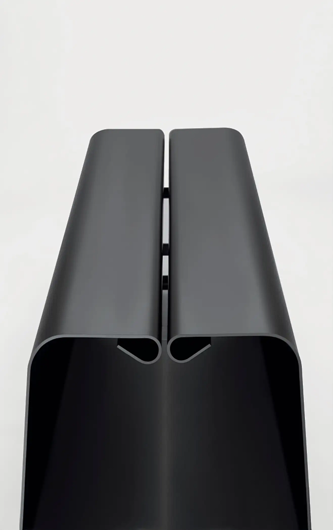 two black metal objects on a white surface with no one around them or ...