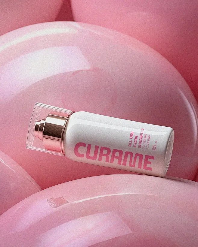 This may contain: a tube of perfume sitting on top of some pink helium ...