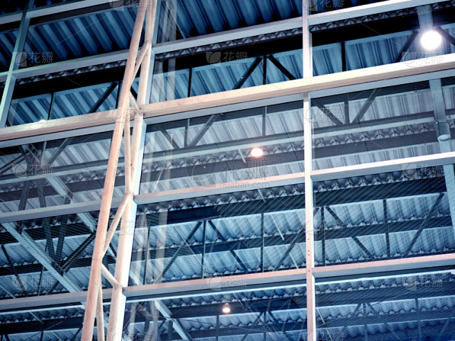 White steel structure wall with glass window, and corrugated roof outside
