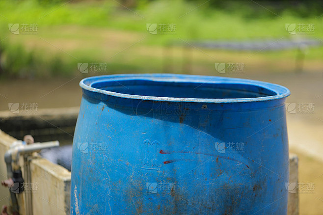 empty plastic drum in farm for water storage