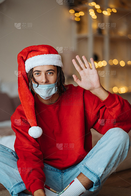 Caucasian guy in face mask and Santa Claus hat loo