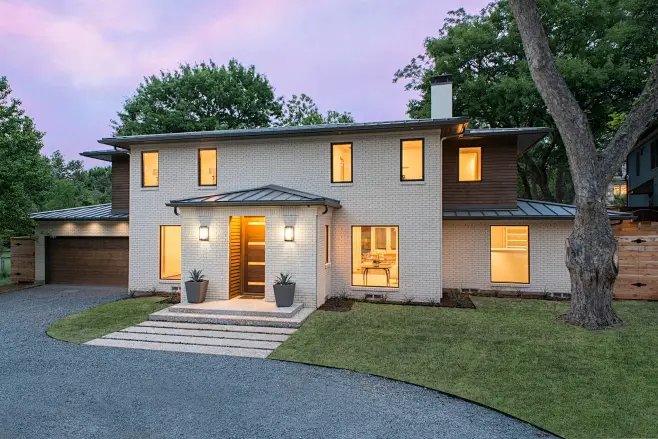 Example of a mid-sized transitional white two-story brick exterior home ...