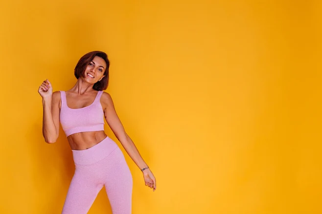 sports-woman-stands-yellow-wall-demonstrating-her-abs-satisfied-with ...