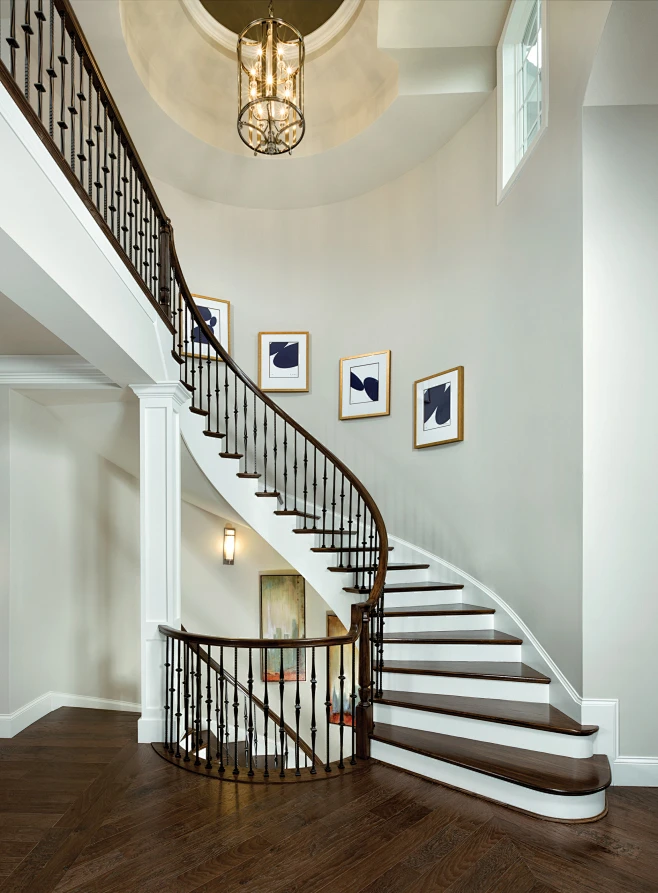Inspiration for a transitional wooden curved staircase remodel in ...
