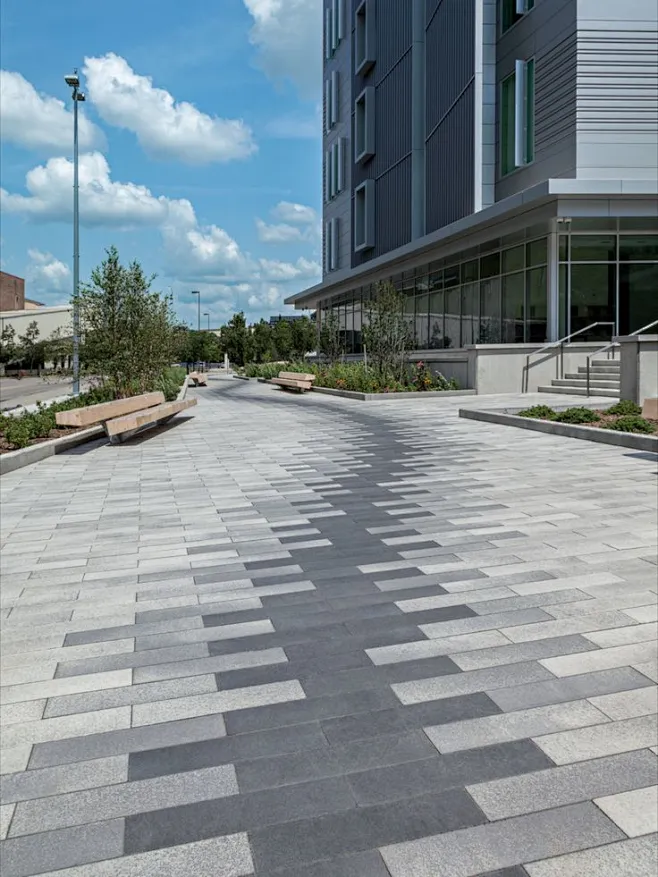 The final paving design using plank pavers evokes movement through the ...