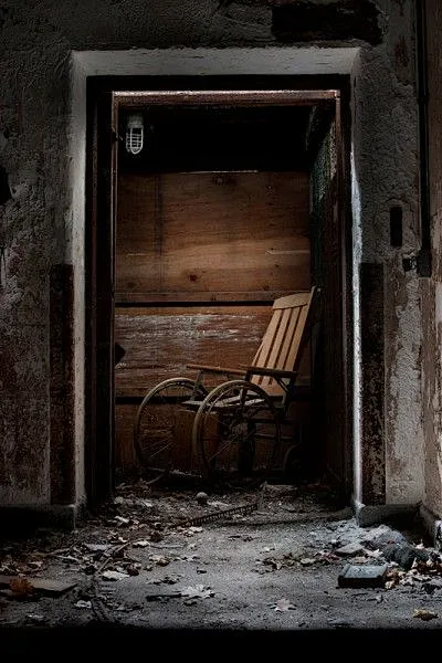 Antique wooden wheelchair in abandoned asylum elevator; Verden ...