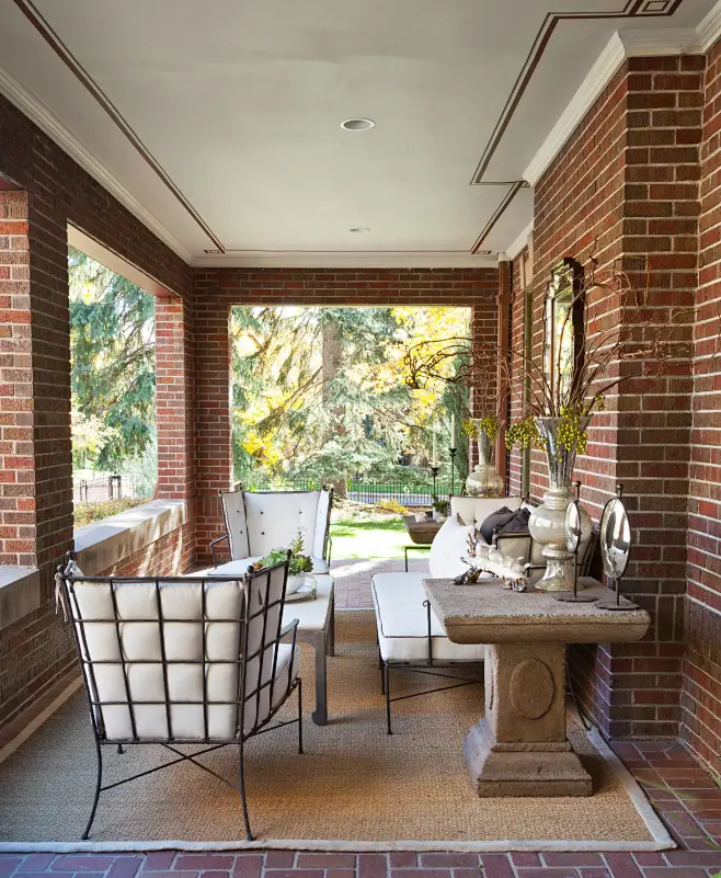 Photo of a traditional veranda in Denver with brick paving and a roof ...
