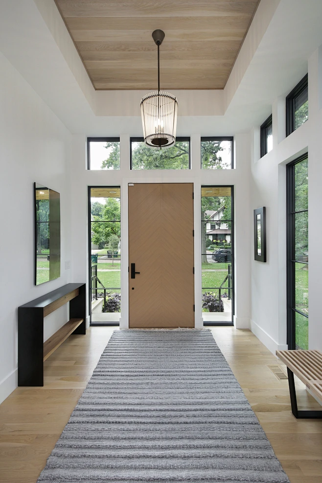 Foyer - large modern light wood floor foyer idea in Chicago with a ...