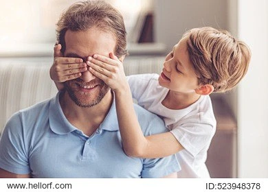 Father and son are smiling while spending time together. Little boy is ...
