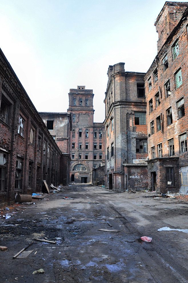 Factory Grounds : Walking down a road surrounded by huge abandoned ...